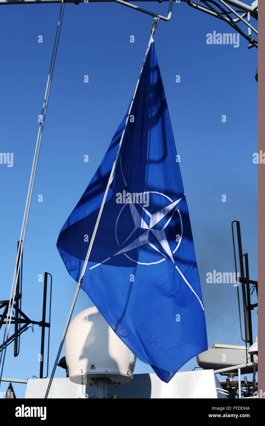 The NATO flag waves aboard the British Royal navy amphibious assault ...