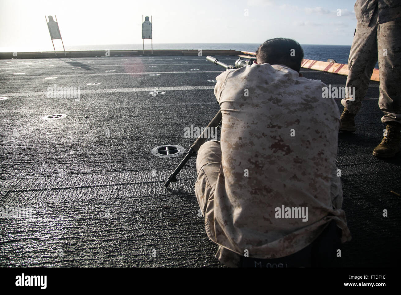 INDIAN OCEAN (July 21, 2015) U.S. Marine Cpl. Roberto Sauceda shoots a ...