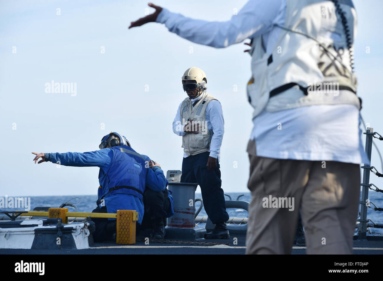 Sailors aboard the USS Ross (DDG 71), an Arleigh Burke-class destroyer ...