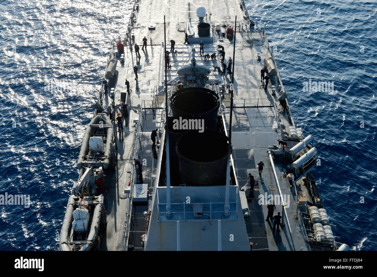 Sailors aboard the USS Ross (DDG 71) conduct a freshwater wash down on ...