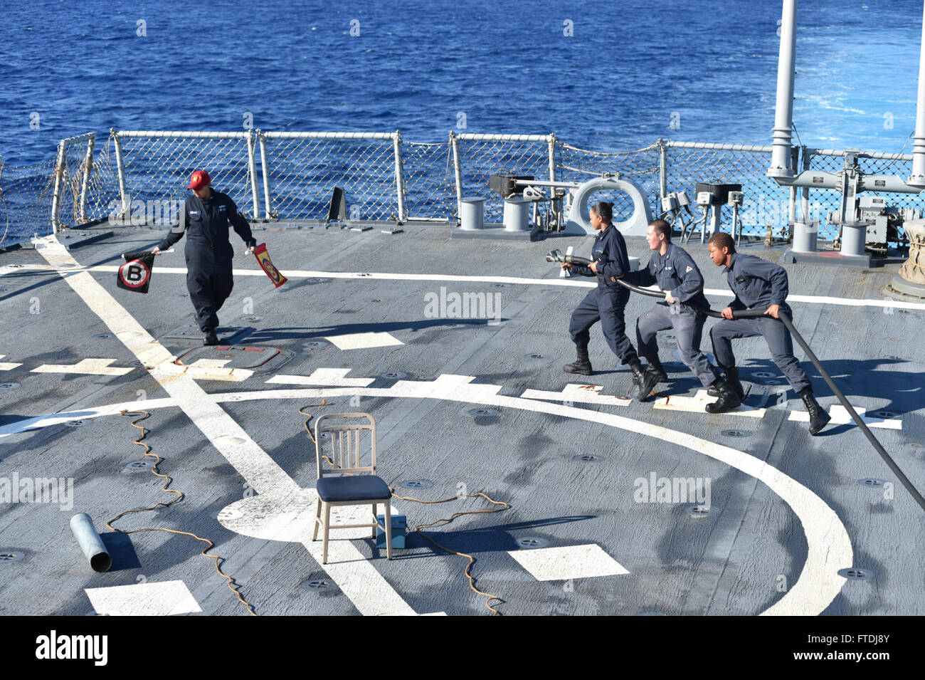 Sailors aboard the USS Ross (DDG 71) conduct flight deck firefighting ...