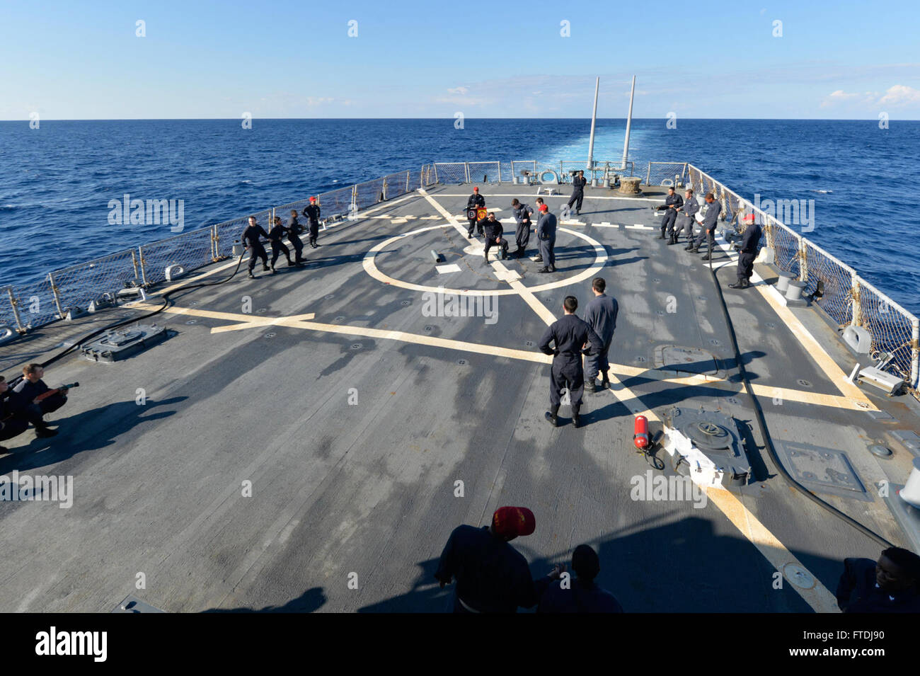 Sailors aboard the USS Ross (DDG 71) conduct flight deck firefighting ...