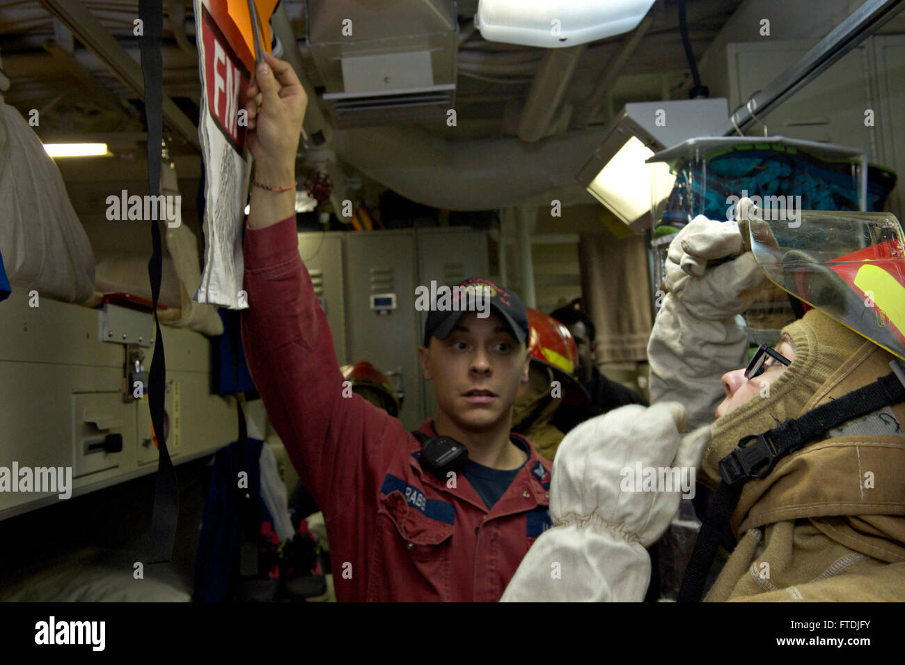 This image shows Damage Controlman 2nd Class Brandon Rabb training ...