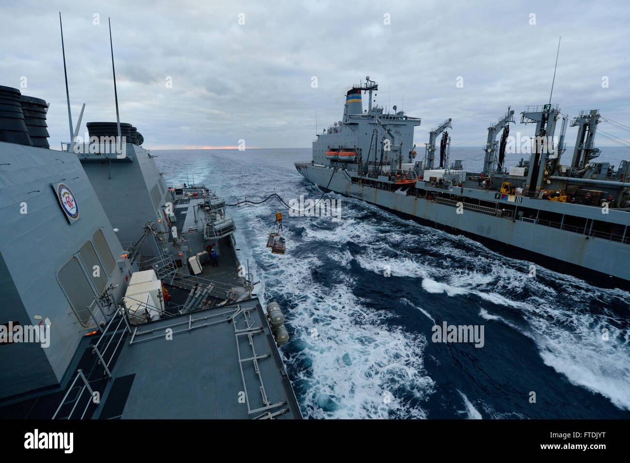 Sailors aboard the USS Ross (DDG 71) conduct a replenishment-at-sea ...