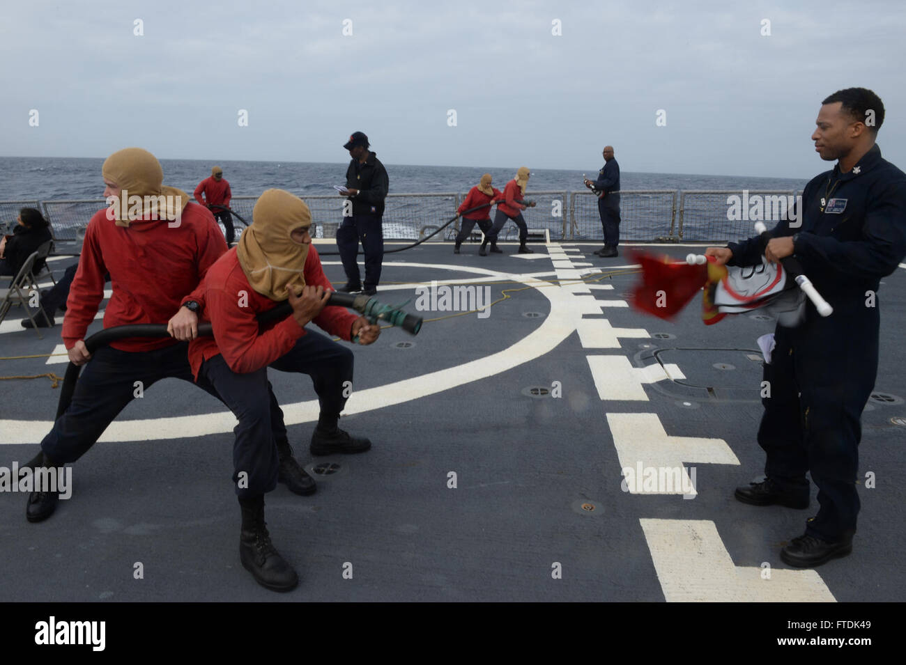 Sailors aboard the USS Carney (DDG 64) fight a simulated class bravo ...