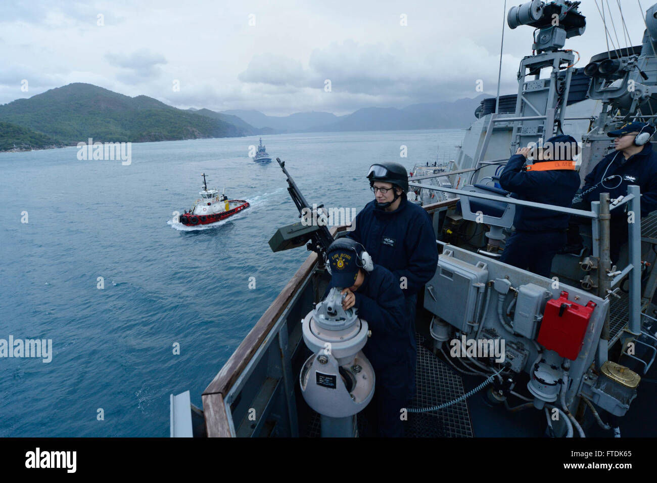 This image shows sailors aboard the USS Ross (DDG 71), an Arleigh Burke ...