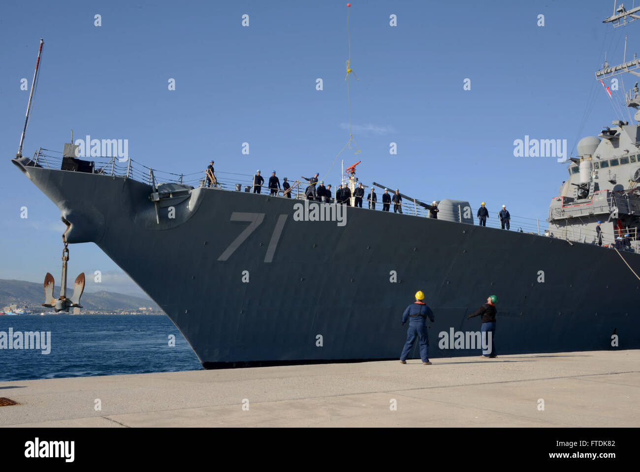 This U.S. Navy photo shows USS Ross (DDG 71) sailors casting shot lines ...