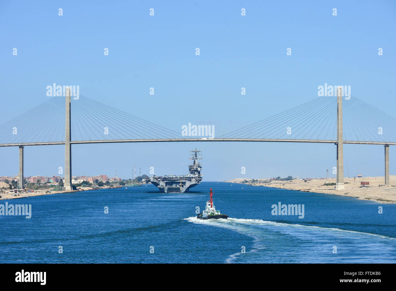 The USS Nimitz (CVN 68) passes under the Friendship Bridge during its ...