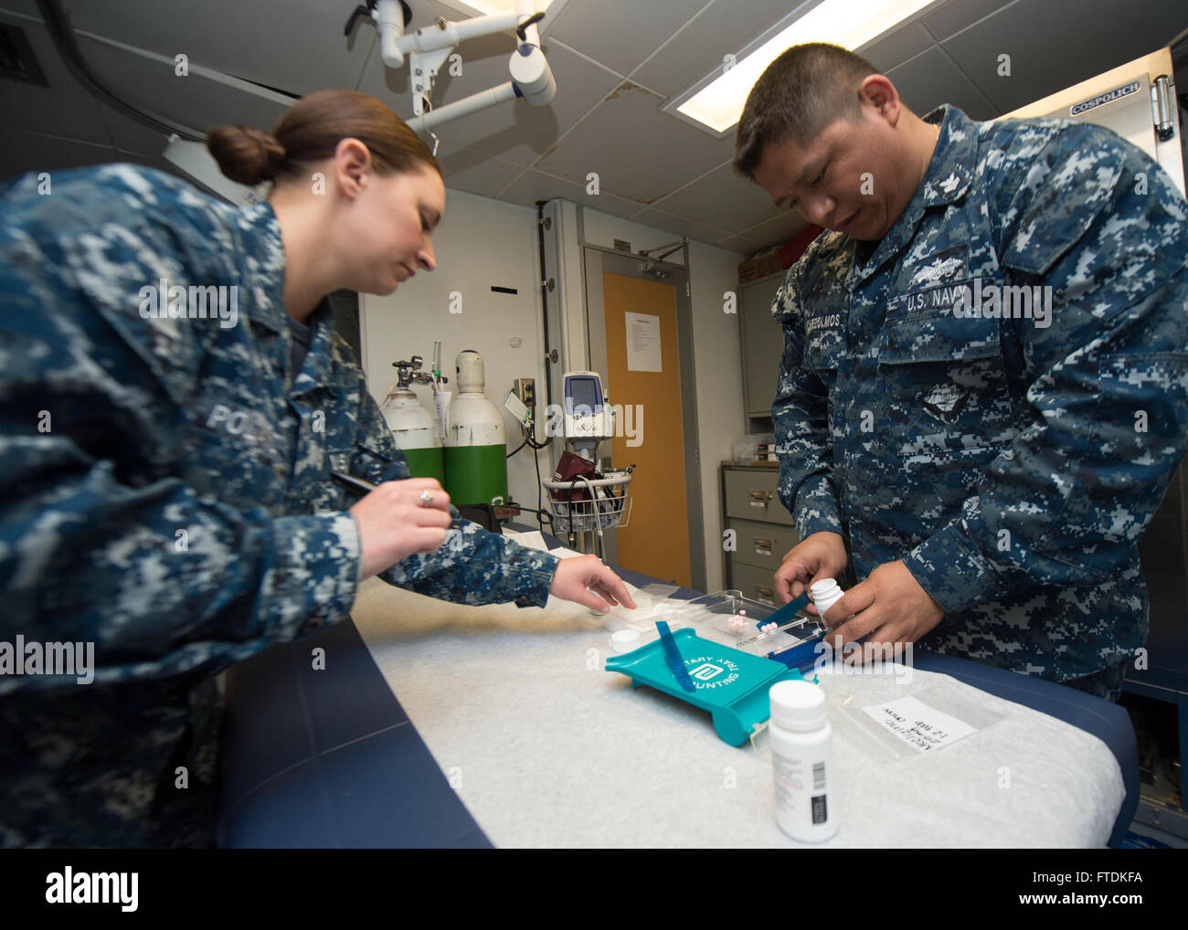 The photo shows Hospital Corpsmen preparing medical supplies aboard the ...