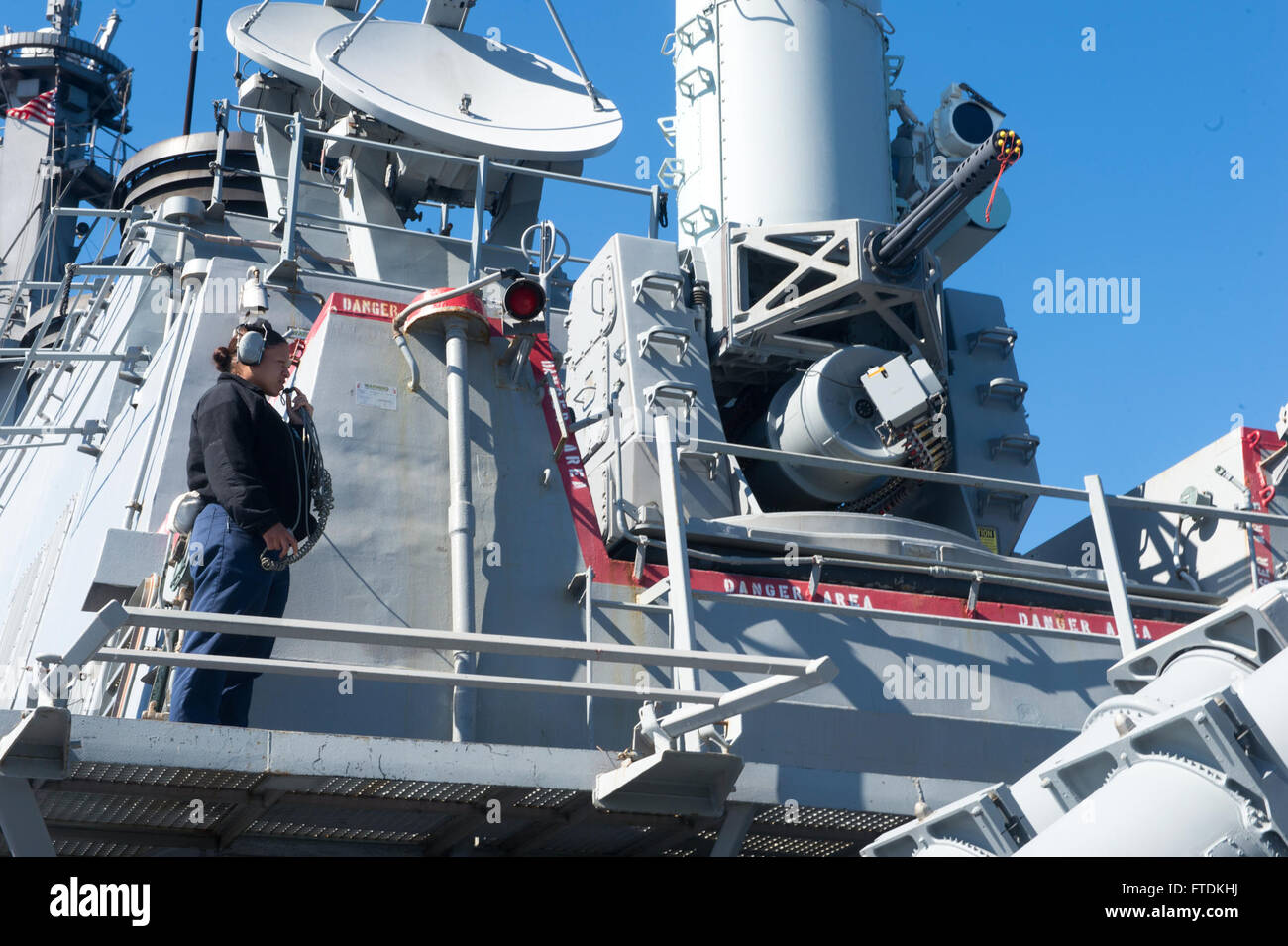 A U.S. Navy Fire Controlman inspects a close-in weapons system aboard ...