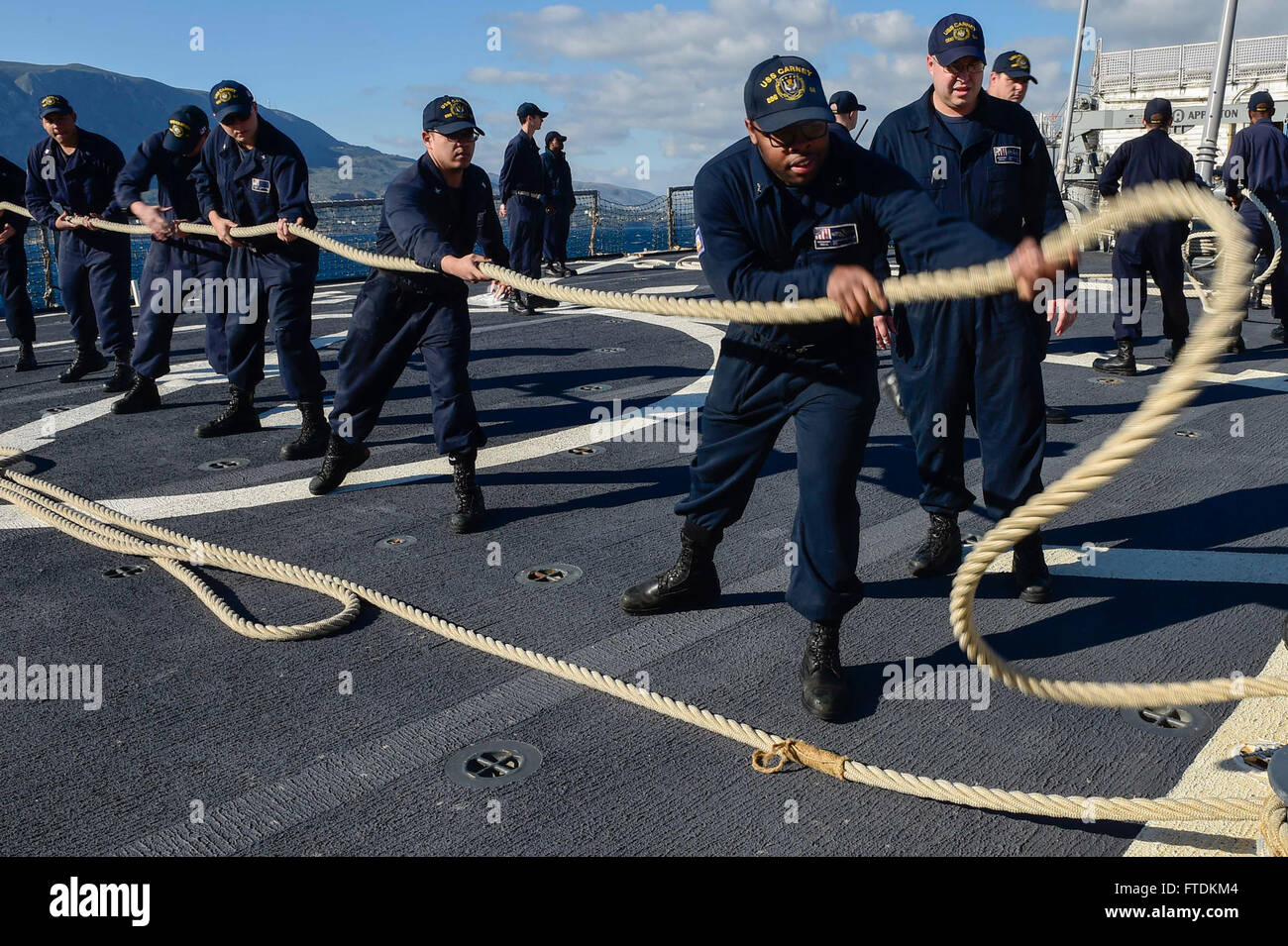 Sailors aboard the USS Carney (DDG 64), an Arleigh Burke-class guided ...