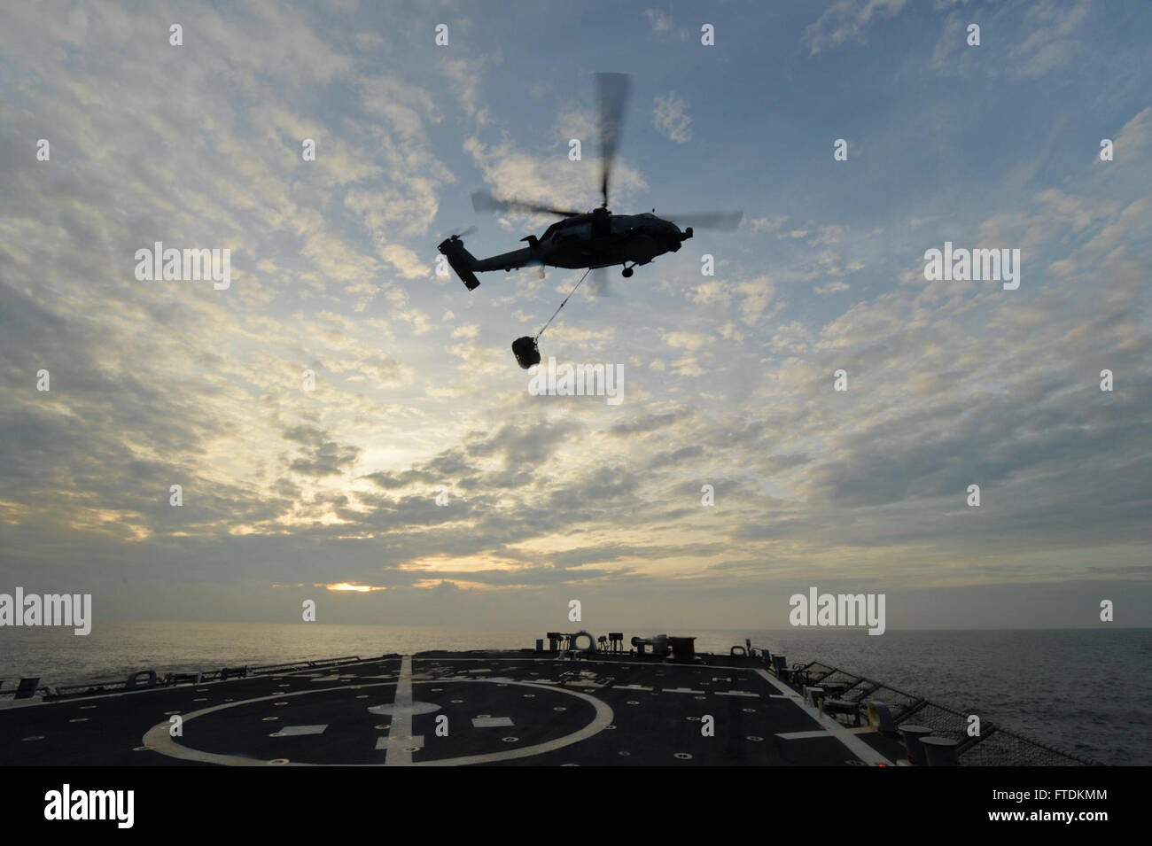 A Spanish SH-60F Sea Hawk helicopter performs vertical replenishment ...