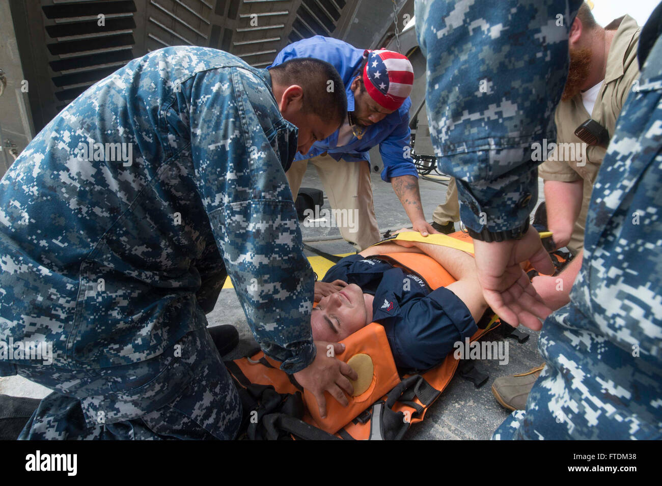 U.S. Navy personnel and civil service mariners aboard the USNS ...