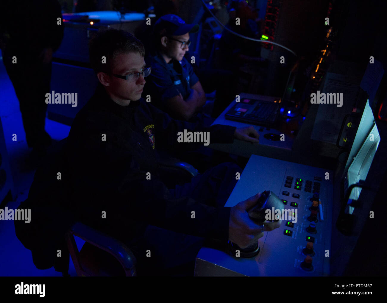 This photograph shows Fire Control Technicians aboard the USS Stout ...