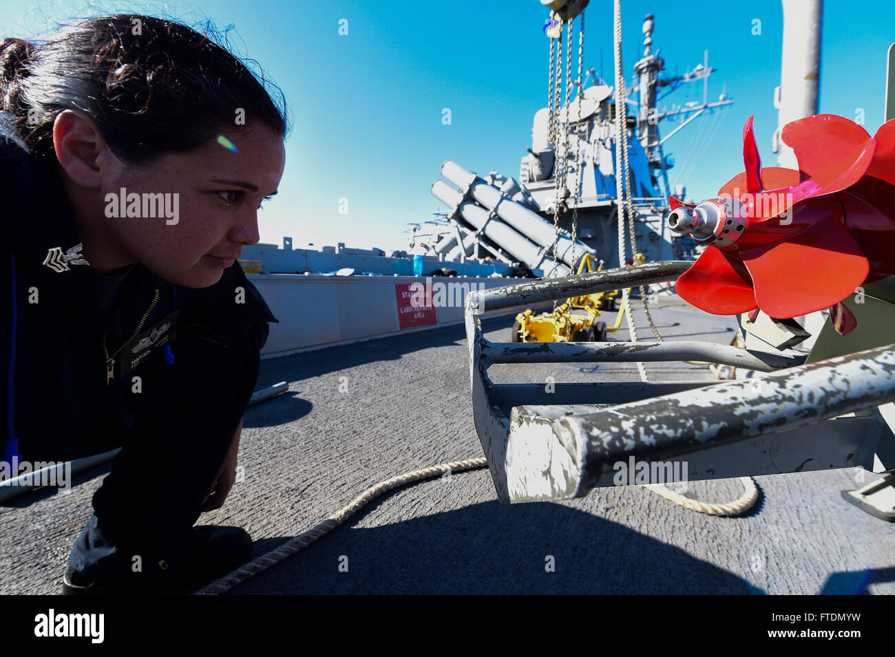 Fire Controlman 1st Class Marisol Erving loads a Mark 46 torpedo into a ...
