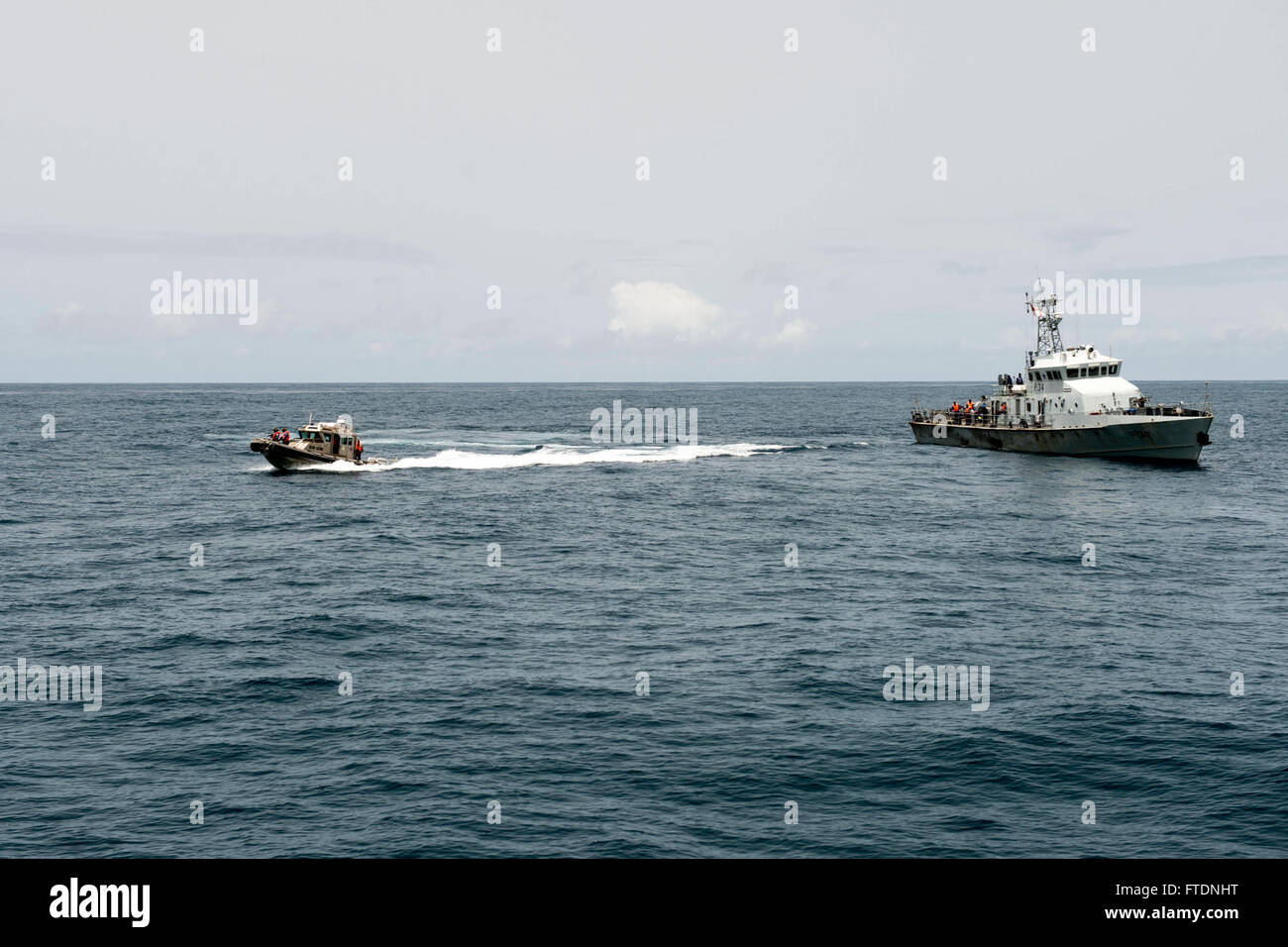 The photo shows a Ghanaian Navy boarding team conducting an operation ...