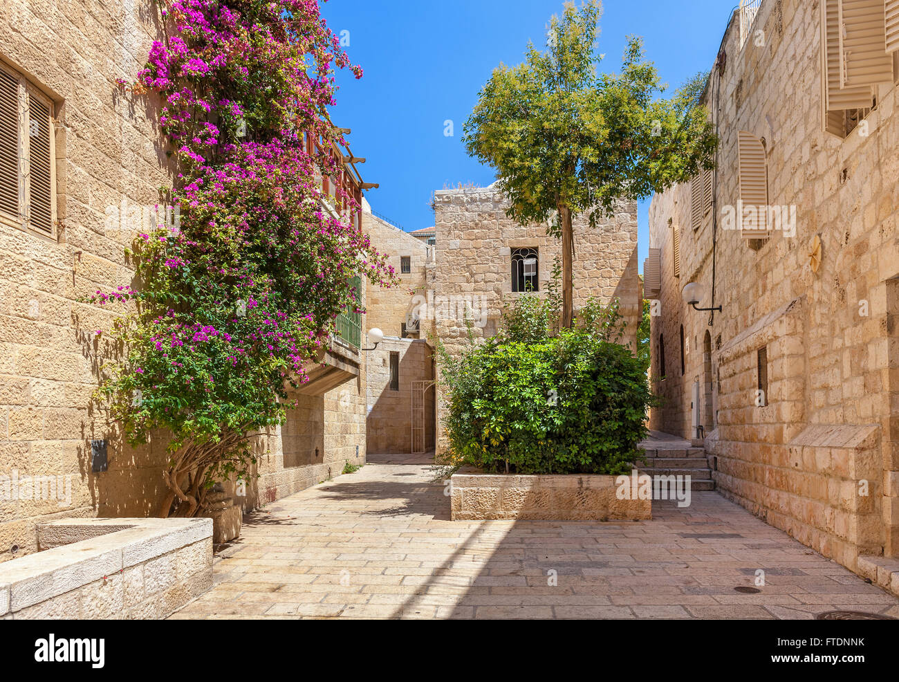 Narrow cobbled street among typical houses of Jewish Quarter in Old ...