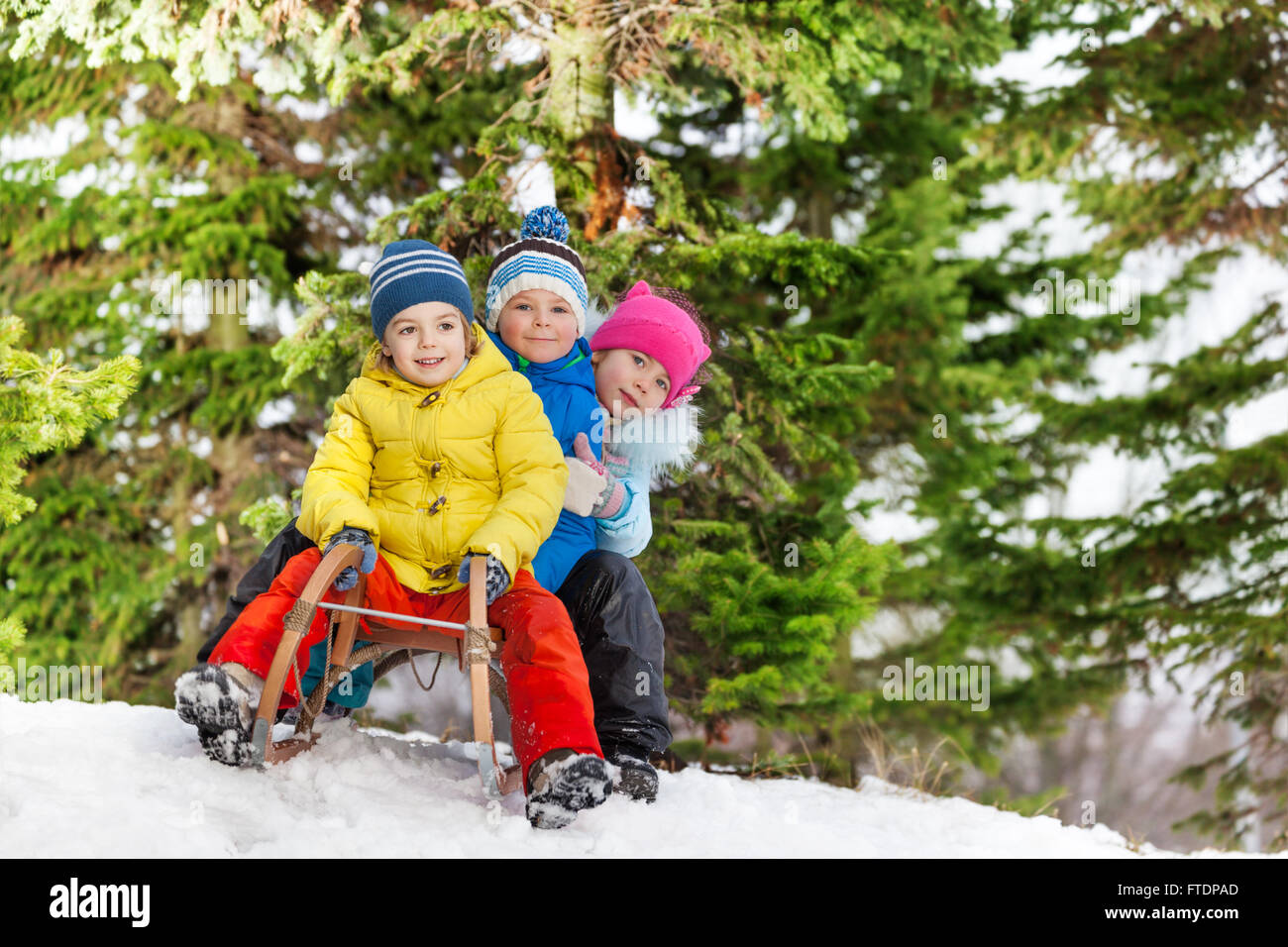 Children little boys and girl slide on sledge Stock Photo - Alamy