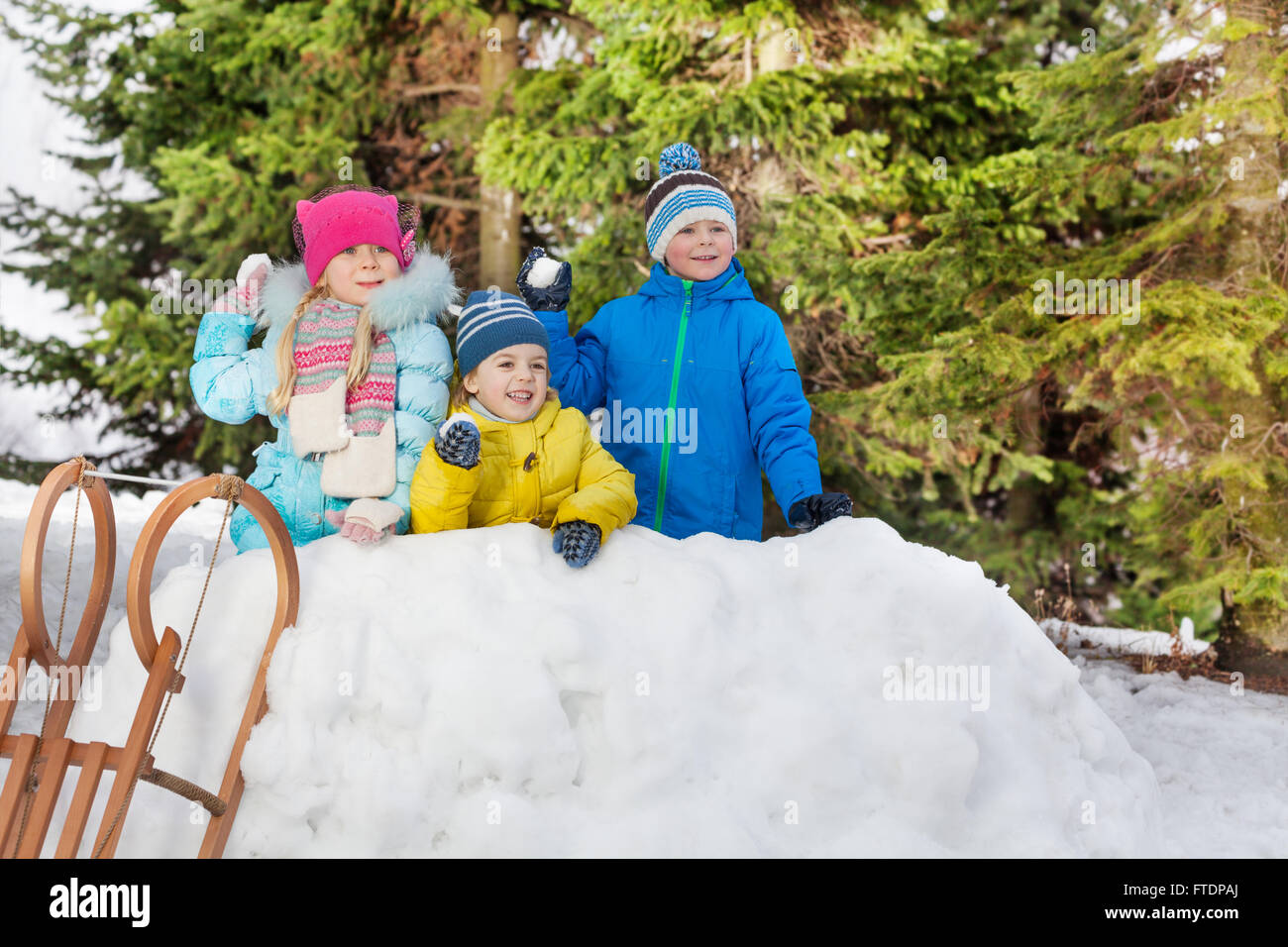 Children in snow fortress play snowball fight Stock Photo - Alamy