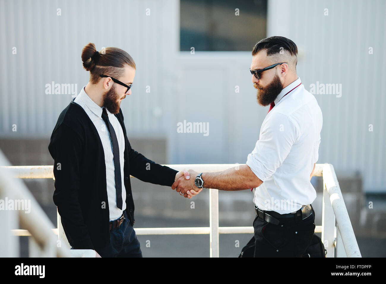 Two businessmen shaking hands Stock Photo - Alamy
