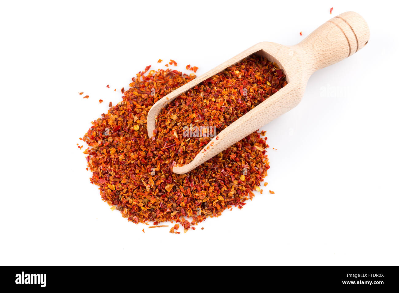 Crushed red chili pepper in spoon on white background Stock Photo - Alamy