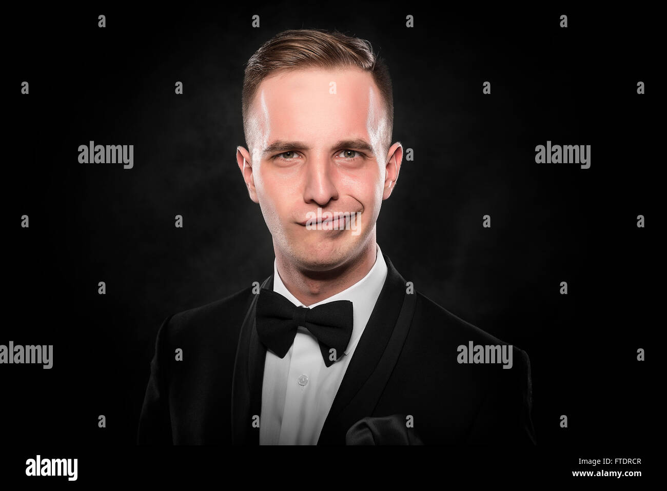 Portrait of a skeptical businessman over dark background Stock Photo ...