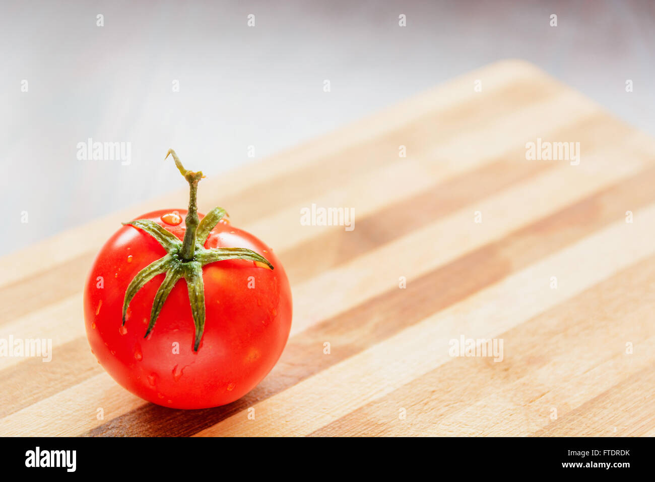 large and red tomato with green leaves Stock Photo - Alamy