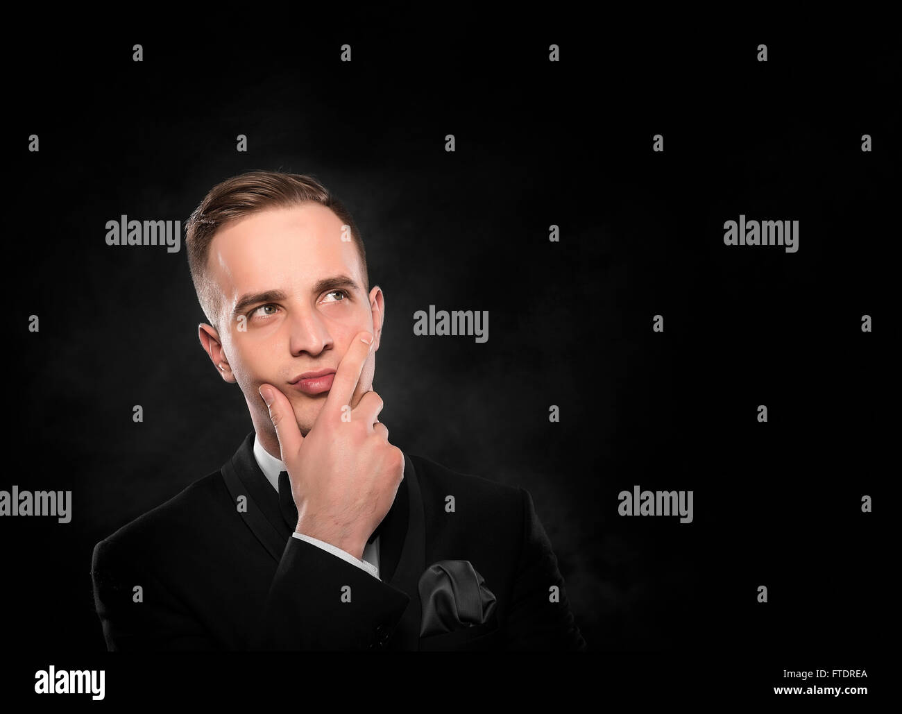 Businessman in black suit thinking hi-res stock photography and images ...