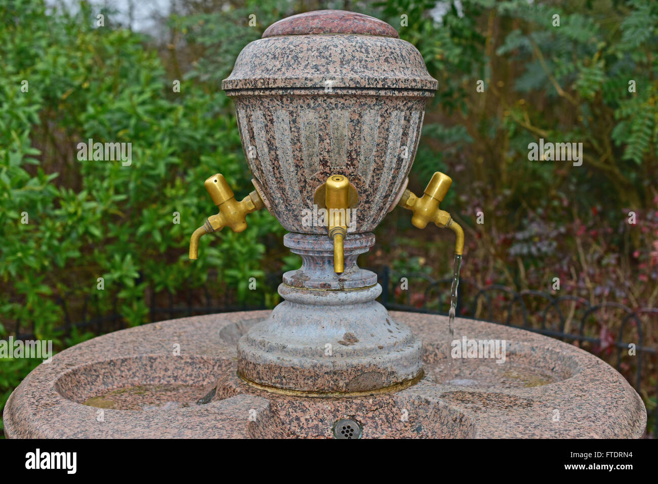 Water fountain in a landscaped alcove in a public park Stock Photo - Alamy