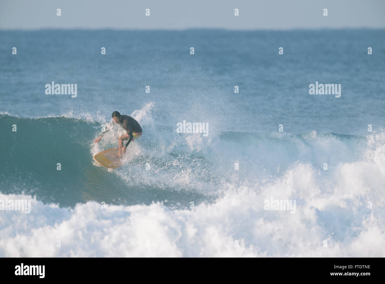 Japanese surfer riding wave Stock Photo - Alamy
