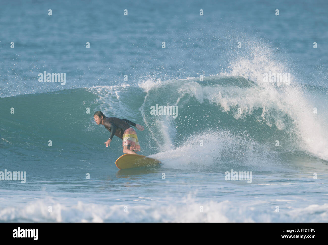 Japanese surfer riding wave Stock Photo - Alamy