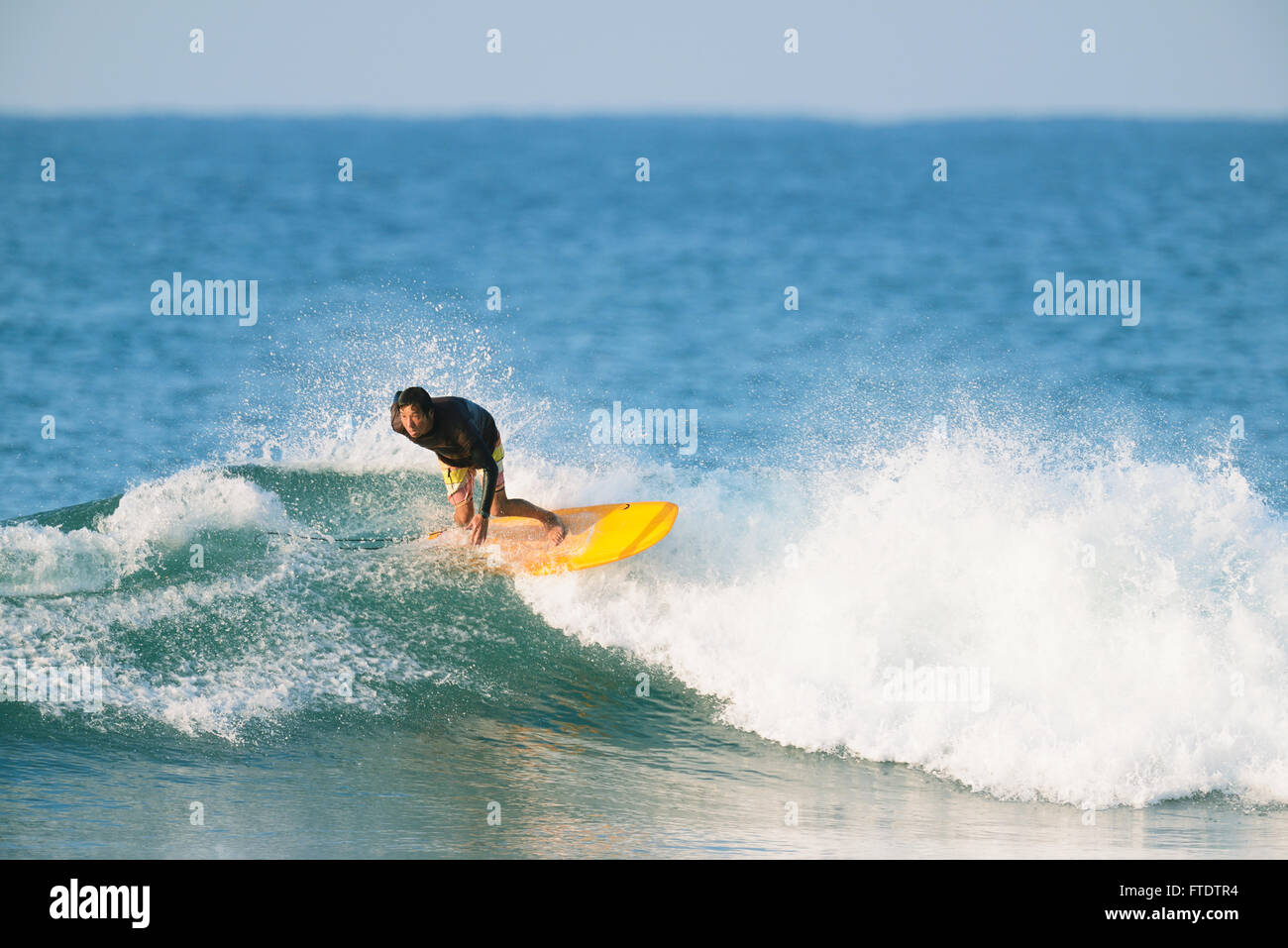 Japanese surfer riding wave Stock Photo - Alamy
