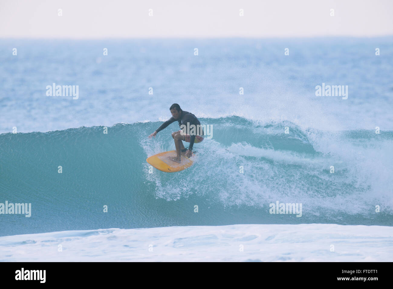 Japanese surfer riding wave Stock Photo - Alamy