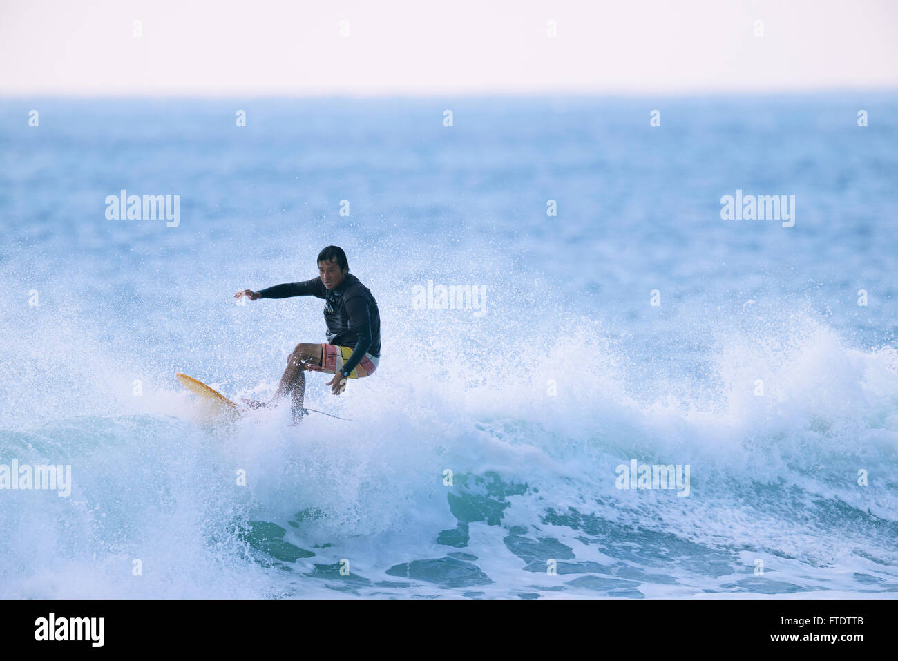 Japanese surfer riding wave Stock Photo - Alamy