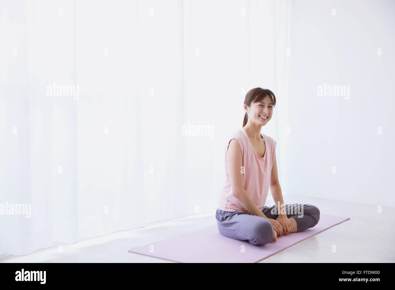 Young Japanese woman practicing yoga Stock Photo - Alamy