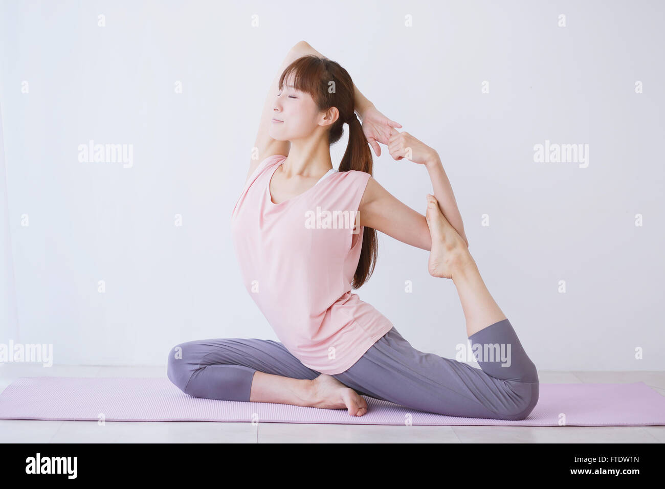 Young Japanese woman practicing yoga Stock Photo - Alamy