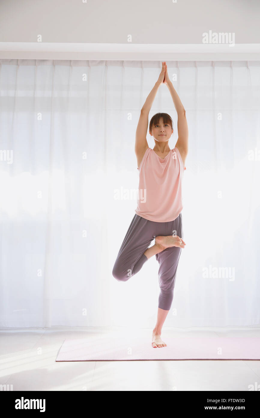 Young Japanese woman practicing yoga Stock Photo - Alamy