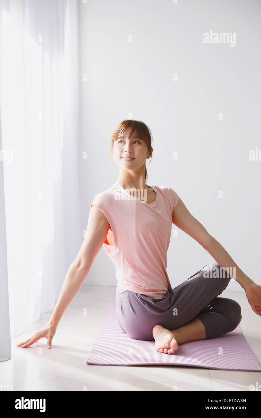 Young Japanese woman practicing yoga Stock Photo - Alamy