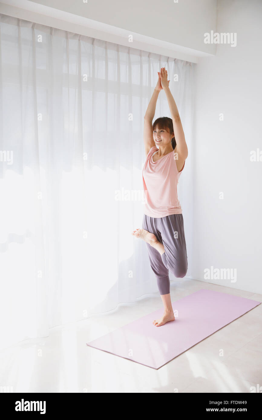 Young Japanese woman practicing yoga Stock Photo - Alamy
