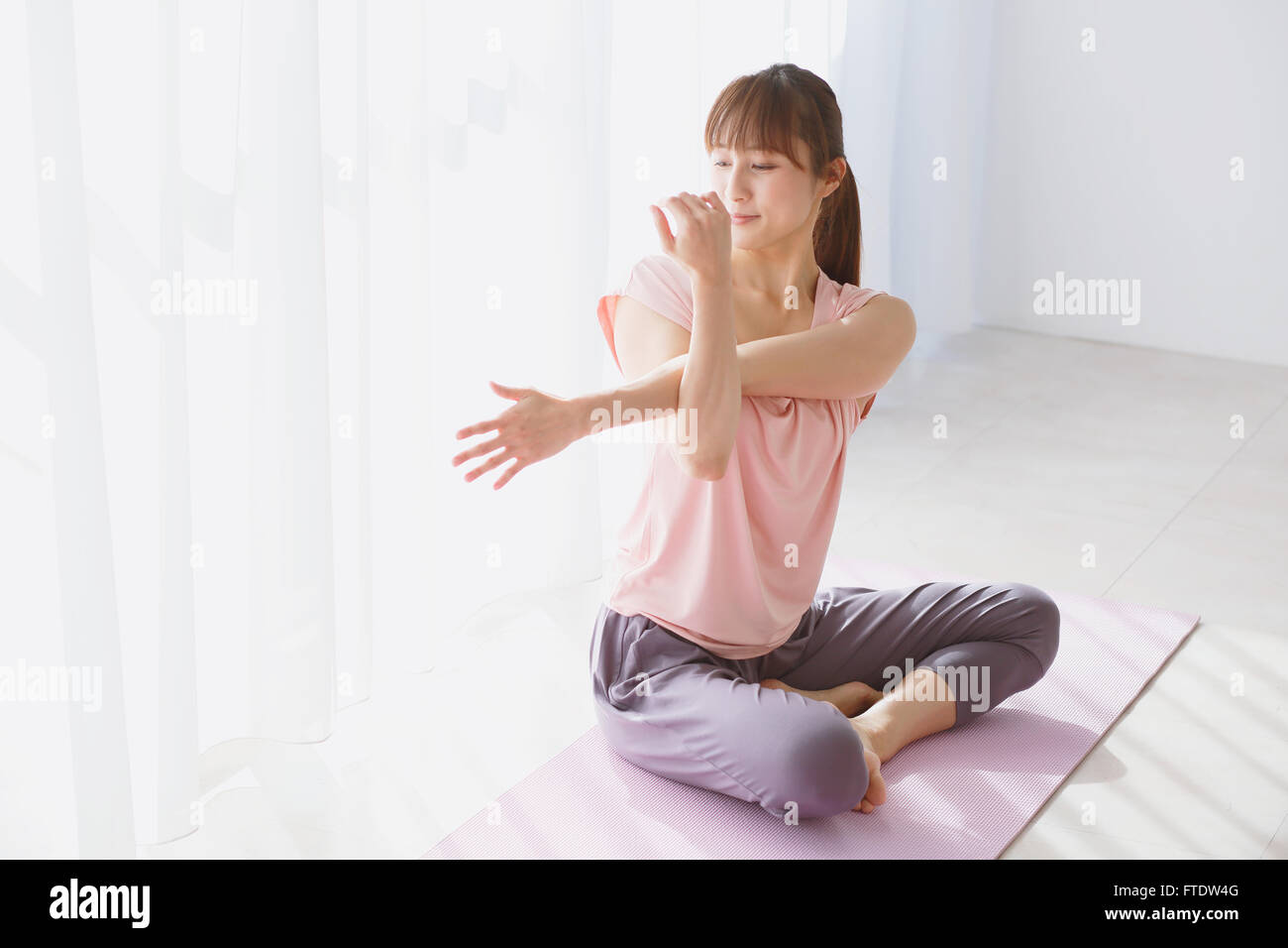 Young Japanese woman practicing yoga Stock Photo - Alamy