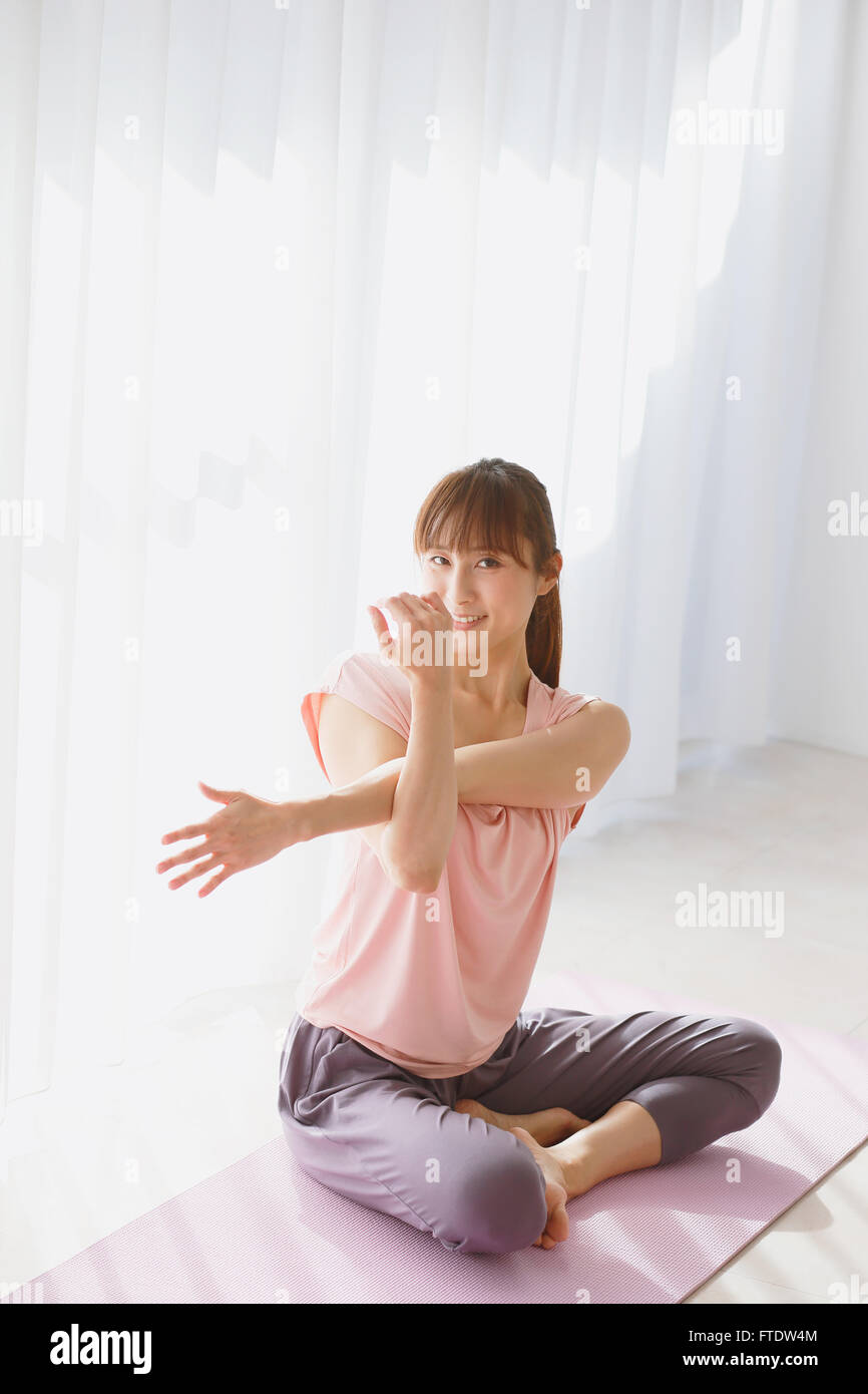 Young Japanese woman practicing yoga Stock Photo - Alamy