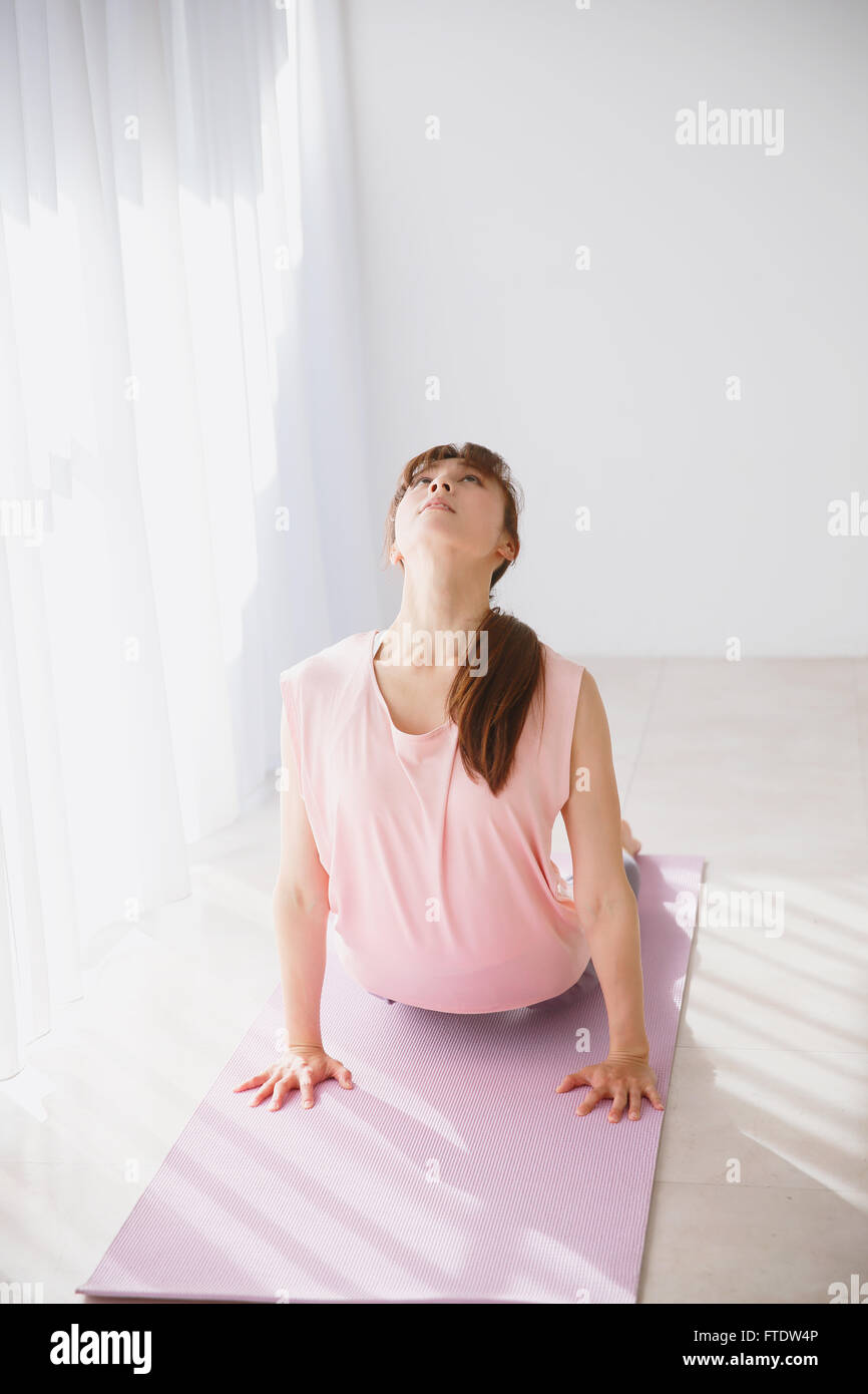 Young Japanese woman practicing yoga Stock Photo - Alamy