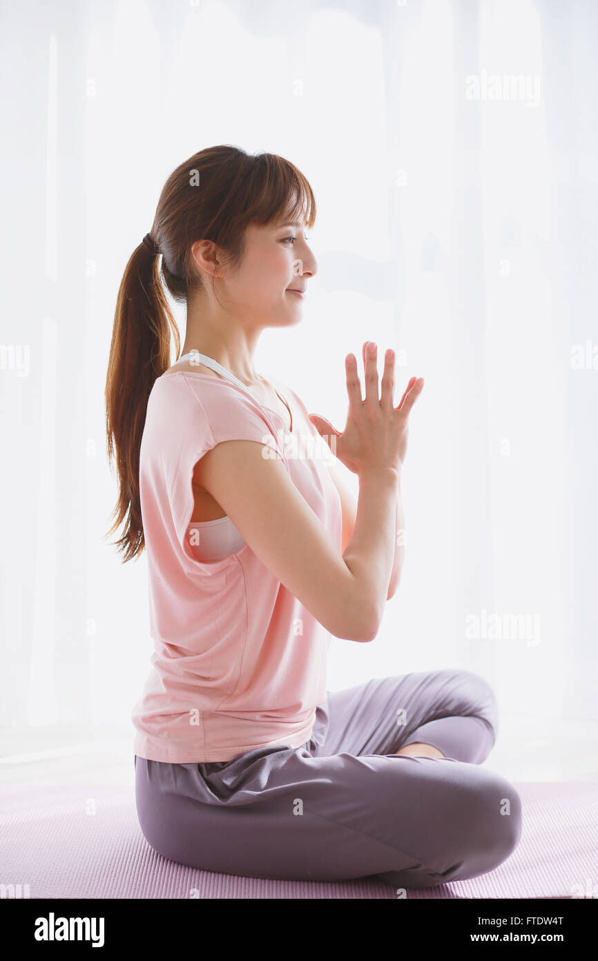 Young Japanese woman practicing yoga Stock Photo - Alamy
