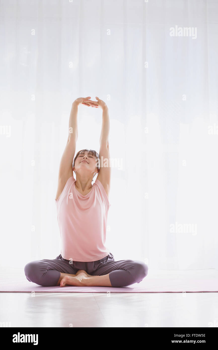 Young Japanese woman practicing yoga Stock Photo - Alamy