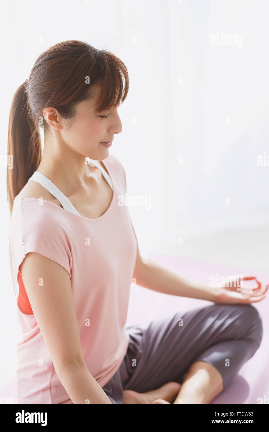 Young Japanese woman practicing yoga Stock Photo - Alamy