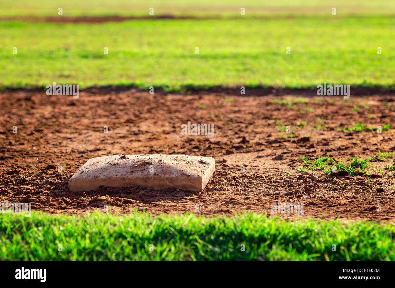 Baseball base featured in empty baseball field Stock Photo - Alamy
