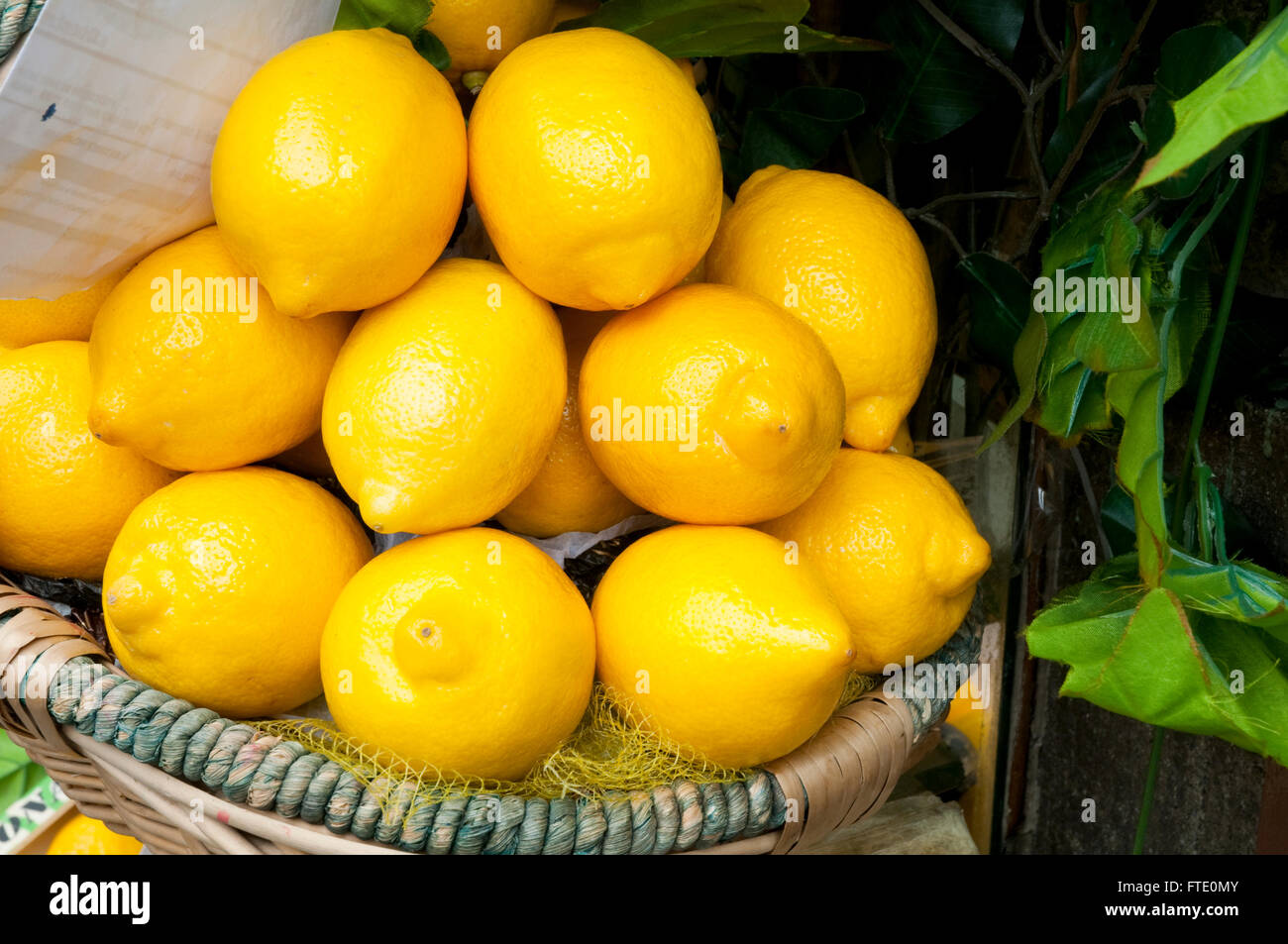 Lemons in a basket Stock Photo - Alamy