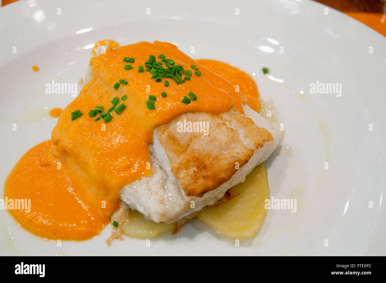 Spanish food: cod with red pepper sauce, Close view Stock Photo - Alamy