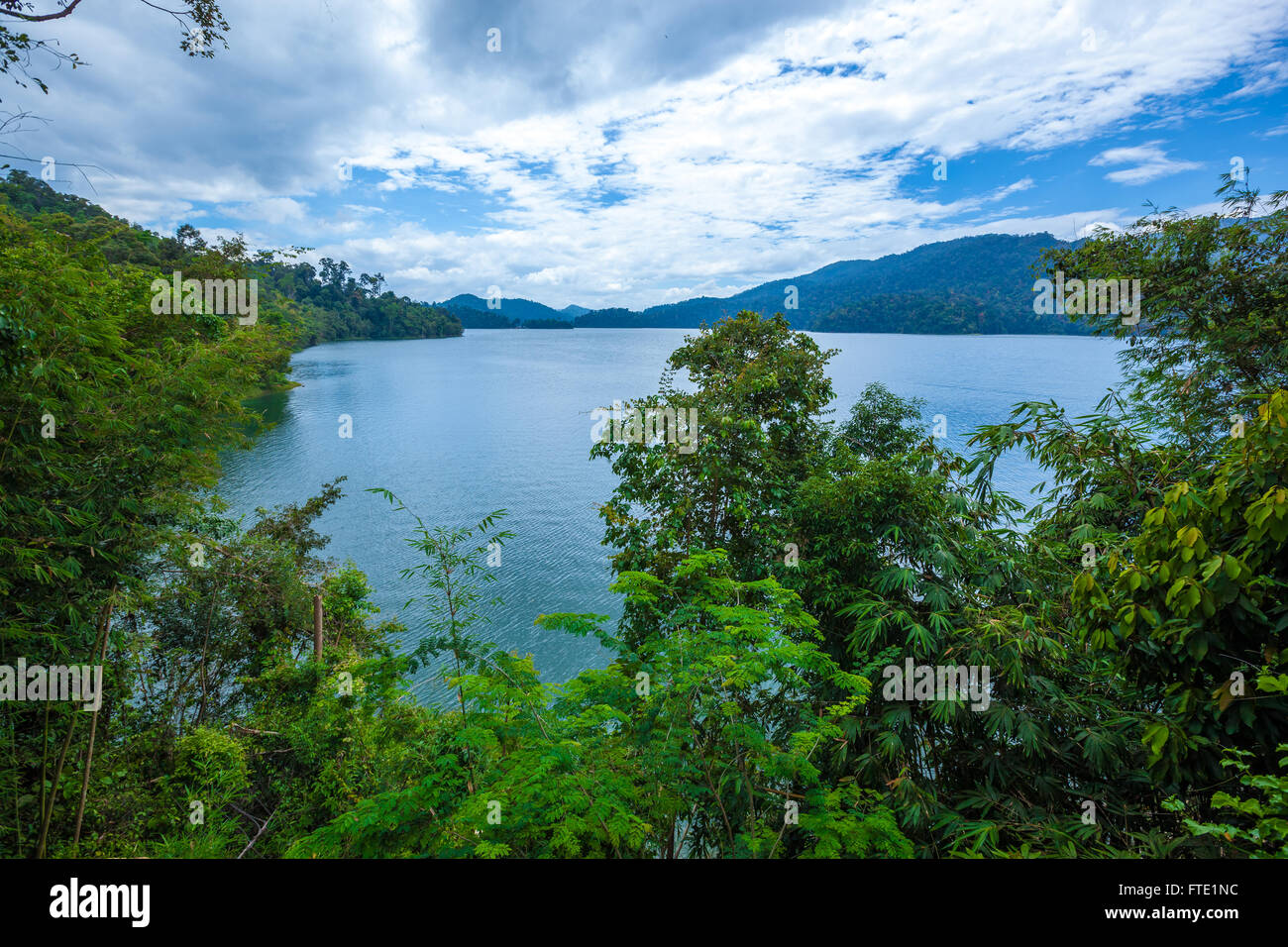 Tropical lake, forest and islands in cloudy blue sky. Belum resort ...