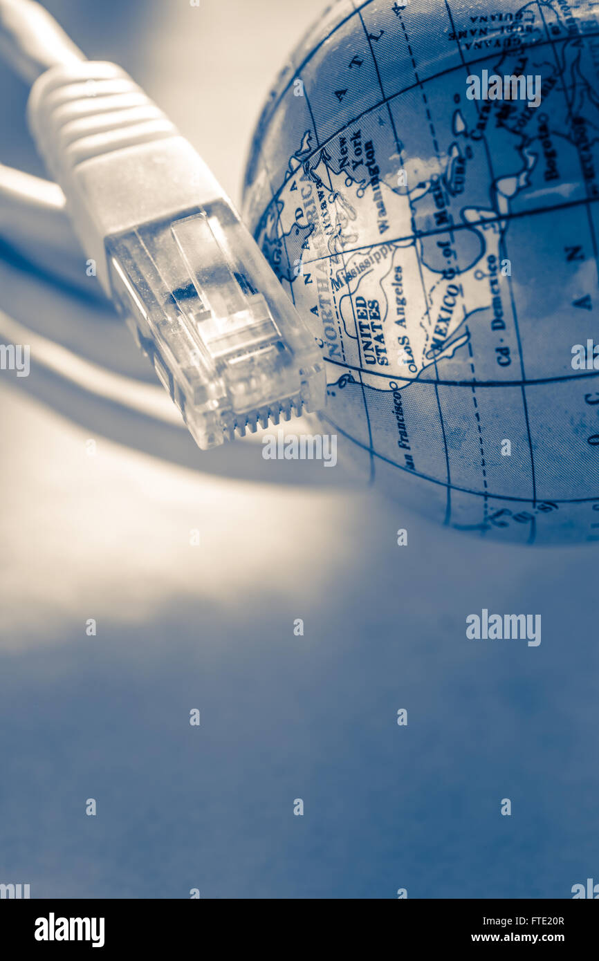 Ethernet cable for computer and globe in toning Stock Photo - Alamy